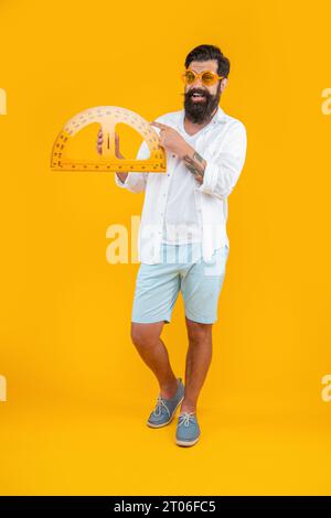 cheerful man with geometry protractor on background. photo of man with ...