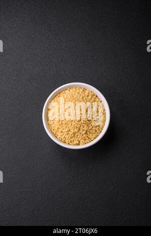 Raw whole grain orzo pasta as an ingredient for a delicious dish Stock ...