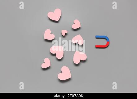 Magnet with paper hearts on pink background. Love concept Stock Photo ...
