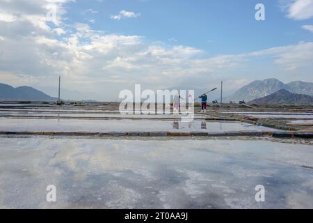 Salt farmers are making salt, the salt fields are pure white, men and ...