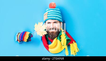 Man with colorful hat, scarf and gloves with yellow axe Stock Photo - Alamy