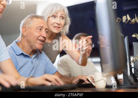 Female mentor teacher and male university student together inside the ...