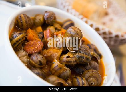 Home style snails stewed with chorizo Stock Photo - Alamy