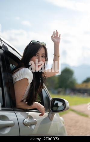 Asian woman waving hand during video call on tablet at home Stock Photo ...