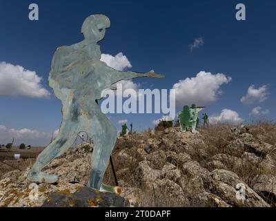 Soldier-shaped metal statues in combat position at an army post from ...