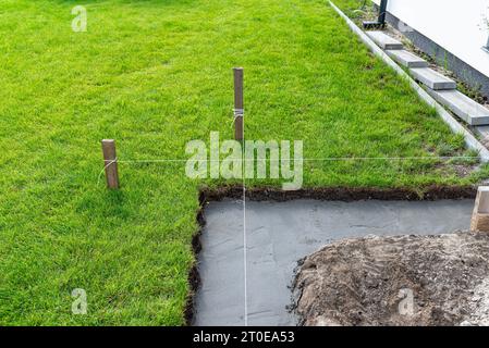 Foundation footings poured in a ditch in the yard, building a terrace ...