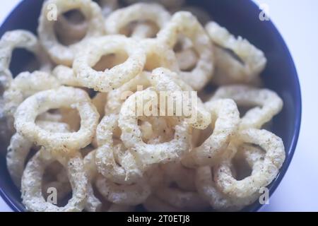 Round corn rings pile with spices. Crunchy puffed snacks close up Stock ...