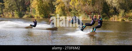 Back view of young man wakeboarding Stock Photo - Alamy