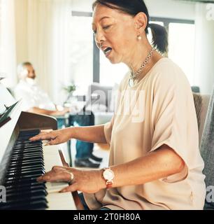 Playing the piano. An elderly lady at the piano, singing the song to ...