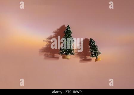 Toy fir trees in rainbow flare leak. Flare glow wintertime holidays ...