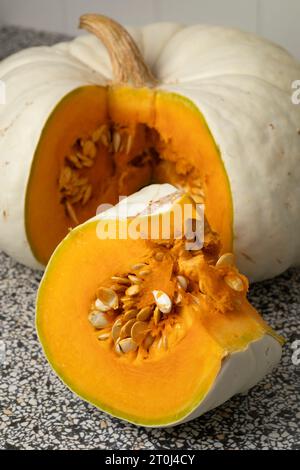 Fresh Flat White Boer Pumpkin and a wedge close up isolated on white ...
