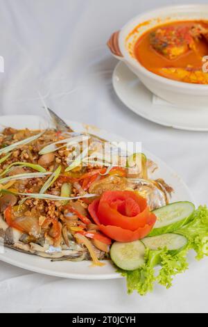 steamed pompano or kuwe fish with sweet and spicy sauce and beautiful ...