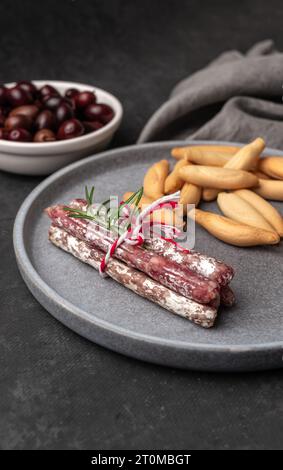 Close-up of Spanish mini fuet on the grey plate Stock Photo - Alamy