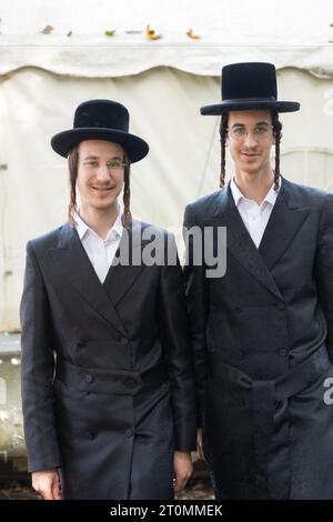 Orthodox Jewish brothers with long peyot pose for a photo outside a ...
