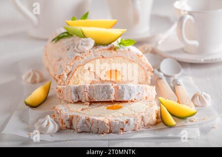 Sweet mango swiss roulade served as summer dessert. Swiss roll with ...