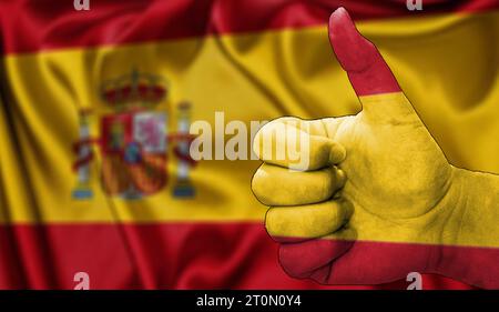 thumbs up in approval with the Spanish flag painted Stock Photo - Alamy