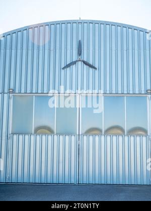 Old carbon propellers mounted on metal sheet hall wall at airport ...