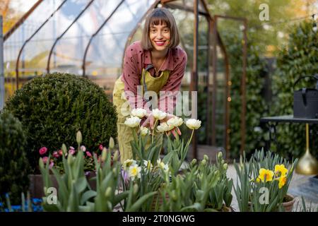 Gardener florist with a flower in a pot isolated on white backgr Stock ...