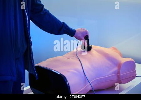 Conducting an ultrasound examination on a training dummy for teaching ...
