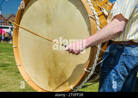 A man plays a traditional Irish Lambeg drum, commonly associated with ...