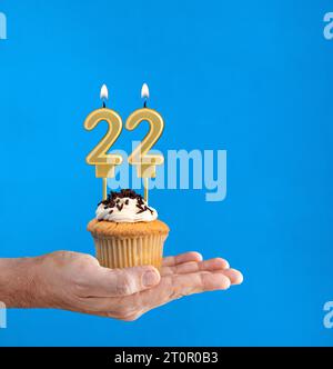 Golden number 22 birthday candle on white background Stock Photo - Alamy