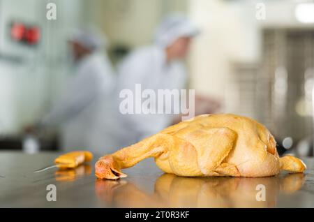 Raw dressed chicken lying on cutting table of butchers shop Stock Photo ...