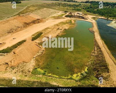 Sand landscape and process of mining and generating product Stock Photo ...