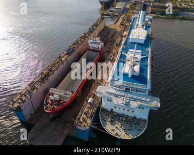 aerial top view shipyard dry dock maintenance and repair cargo ship ...