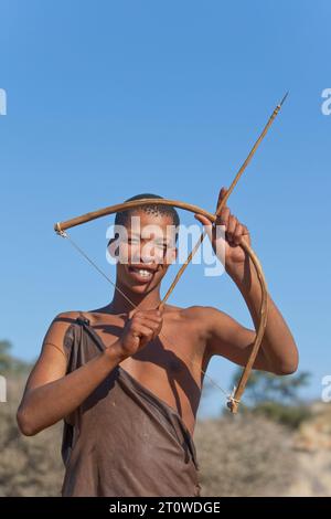 Bushmen of the San people hunting with a bow, Kalahari, Namibia, Africa ...