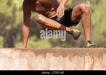 Mud race runners running over obstacles extreme sport Stock Photo - Alamy