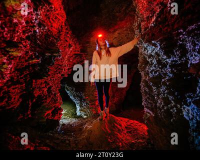 Female digger with flashlight explores the tunnel Stock Photo - Alamy