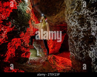 Girl with flashlight explores dark creepy abandoned underground ...