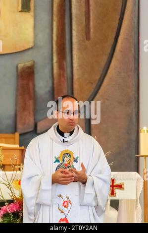 Religion, church and man with priest for communion for ceremony ...