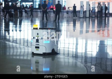An intelligent sweeping robot works at Hangzhou Xiaoshan International ...