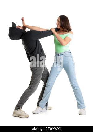 Young woman defending herself against robber on white background Stock ...