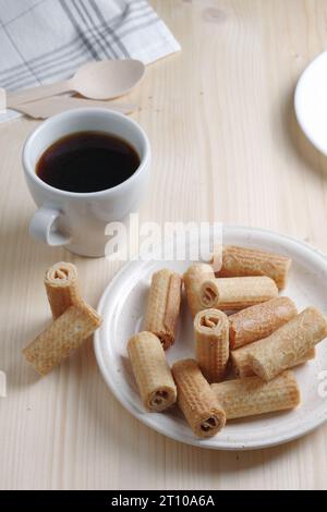 Plate with heap of tasty wafer rolls on grey background Stock Photo - Alamy