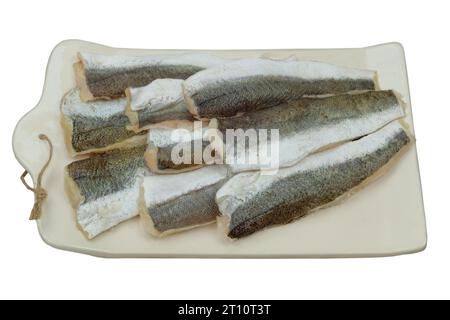 Raw hake on a ceramic board isolated on white background. Ready to ...