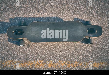 double kick cutaway longboard on asphalt against the background of the ...