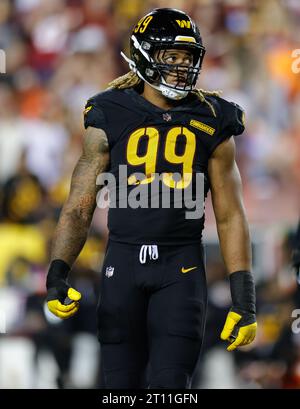 Washington Commanders' defensive end Chase Young speaks to reporters as ...