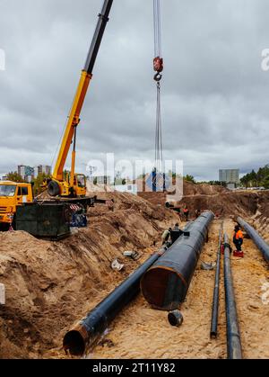 Process of laying and joining of water supply or sewer pipes. Lifting ...
