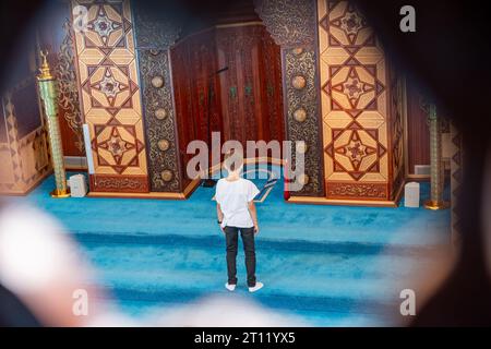 Child is praying inside mosque behind of imam place Stock Photo - Alamy