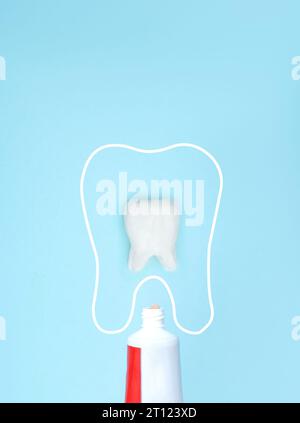 Small Red Toothpaste Tube with open lid on blue background. Means to ...