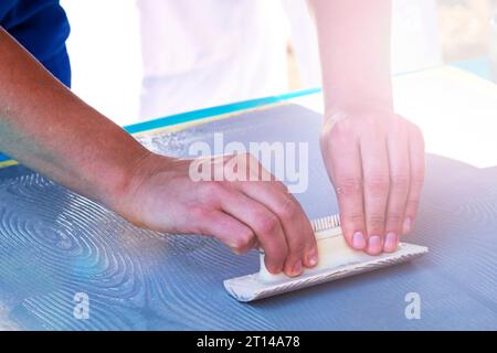 painter, decorator, plasterer. Hand with trowel. Decorative plaster ...