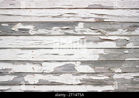 Weathered wooden boards with cracked surface and peeling green and red ...