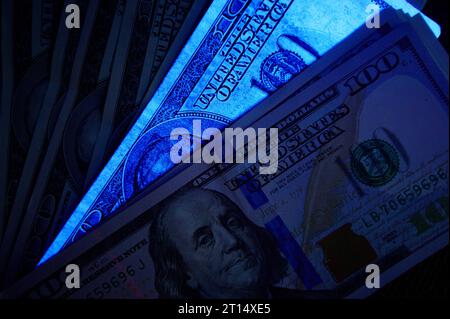 Dollar bill in uv light, fraud check Stock Photo - Alamy