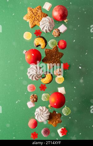 Flying Christmas balls on green background Stock Photo - Alamy