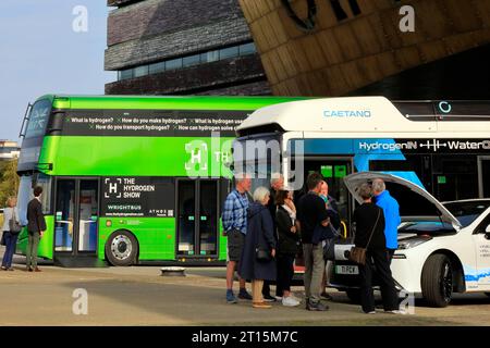 Buses and cars at an event for promoting Hydrogen Powered Vehicles with ...