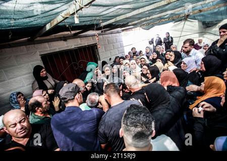 Tulkarm, Palestine. 11th Oct, 2023. A house seen with a hole caused by ...