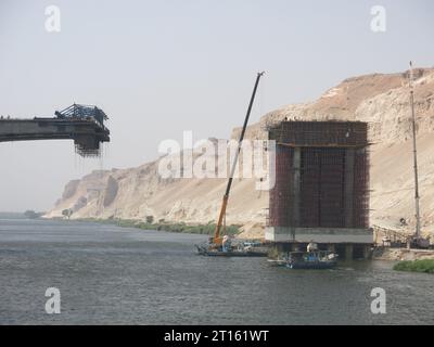 A new, massive bridge construction is underway at Manfalut to connect ...
