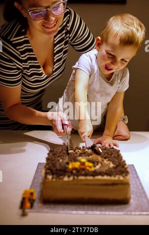 Cute little toddler cutting his birthday cake Stock Photo - Alamy